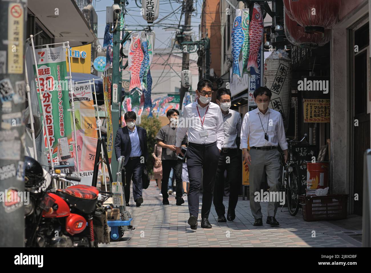 Tokyo, Japan. 18th May, 2022. Office workers walk through a restaurant ...