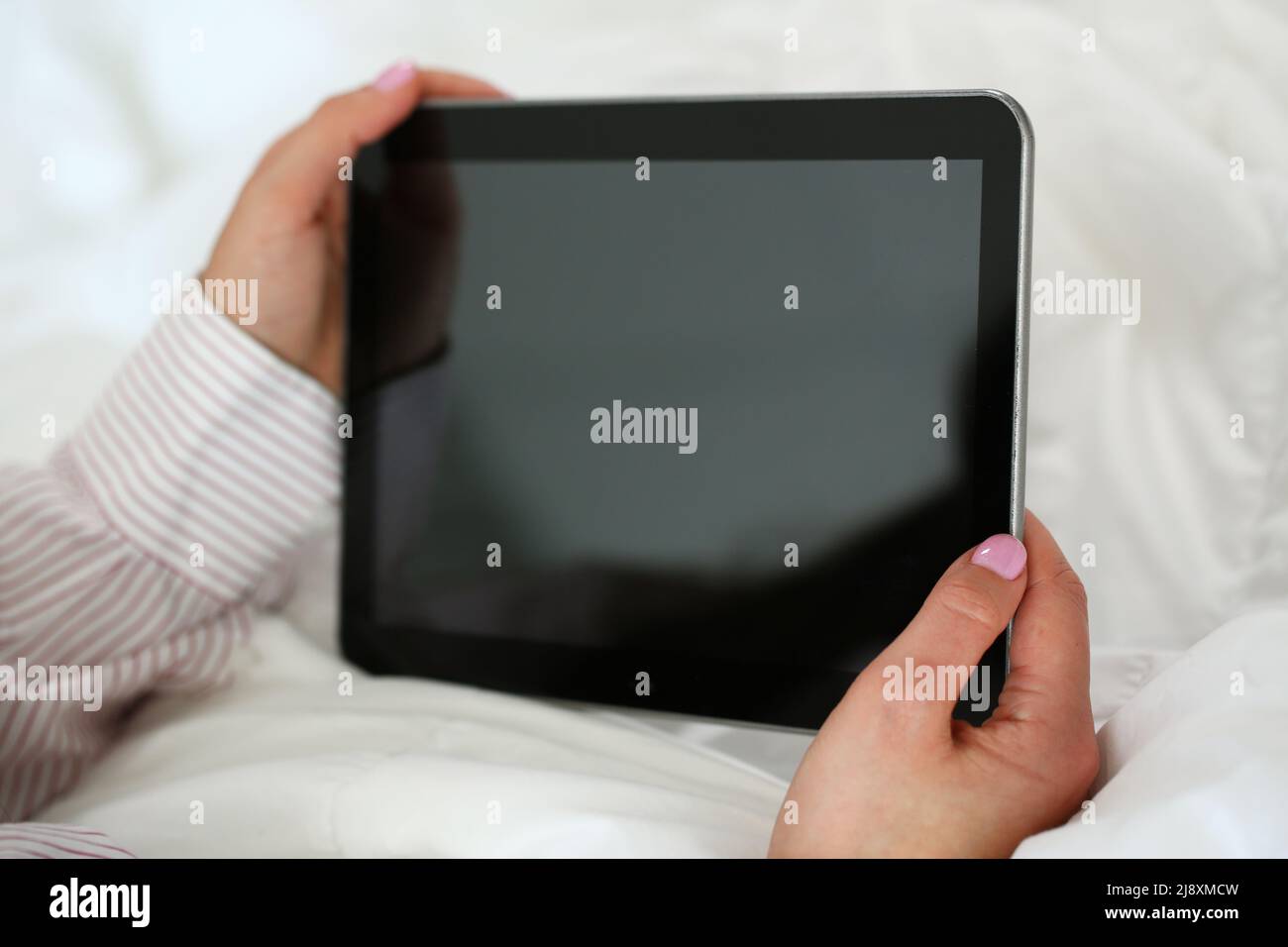 Woman holding tablet device with locked screen, turned off gadget Stock ...