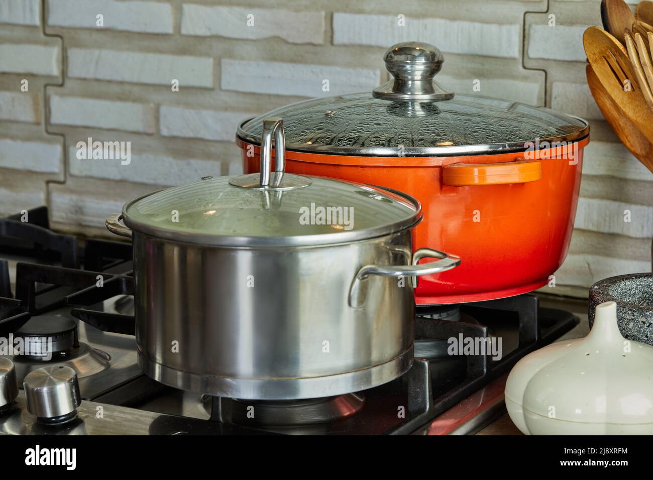 Pots with cooking food in the kitchen on gas stove Stock Photo - Alamy