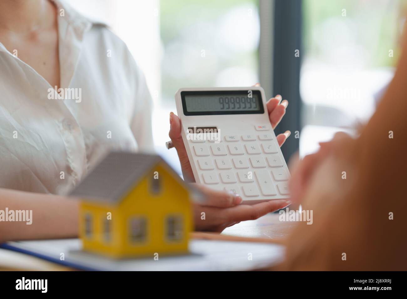 A woman holding and checking house model .Real Estate House Appraisal ...
