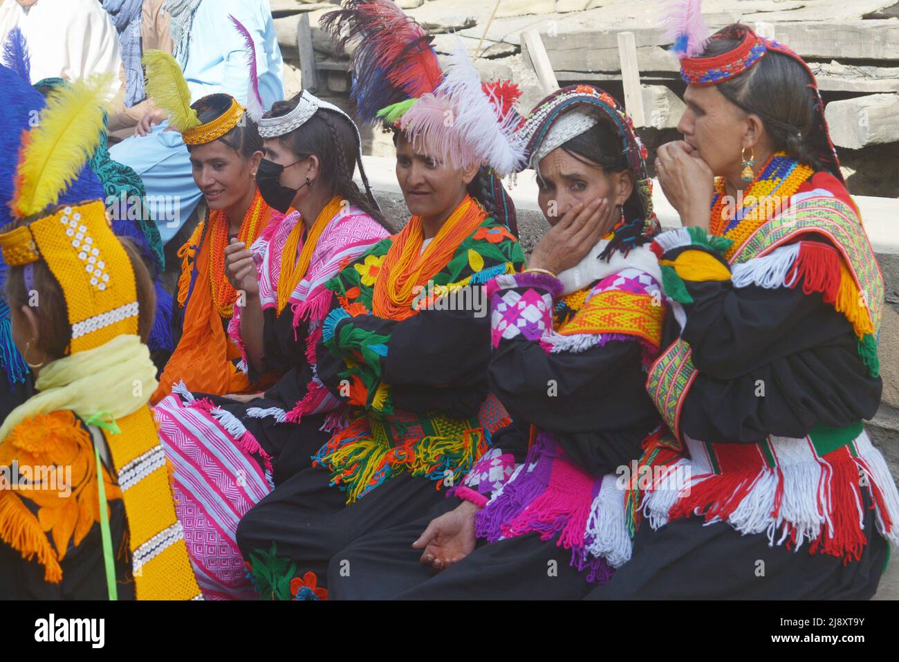 Kalashi women and men wearing traditional dresses participating in the ...