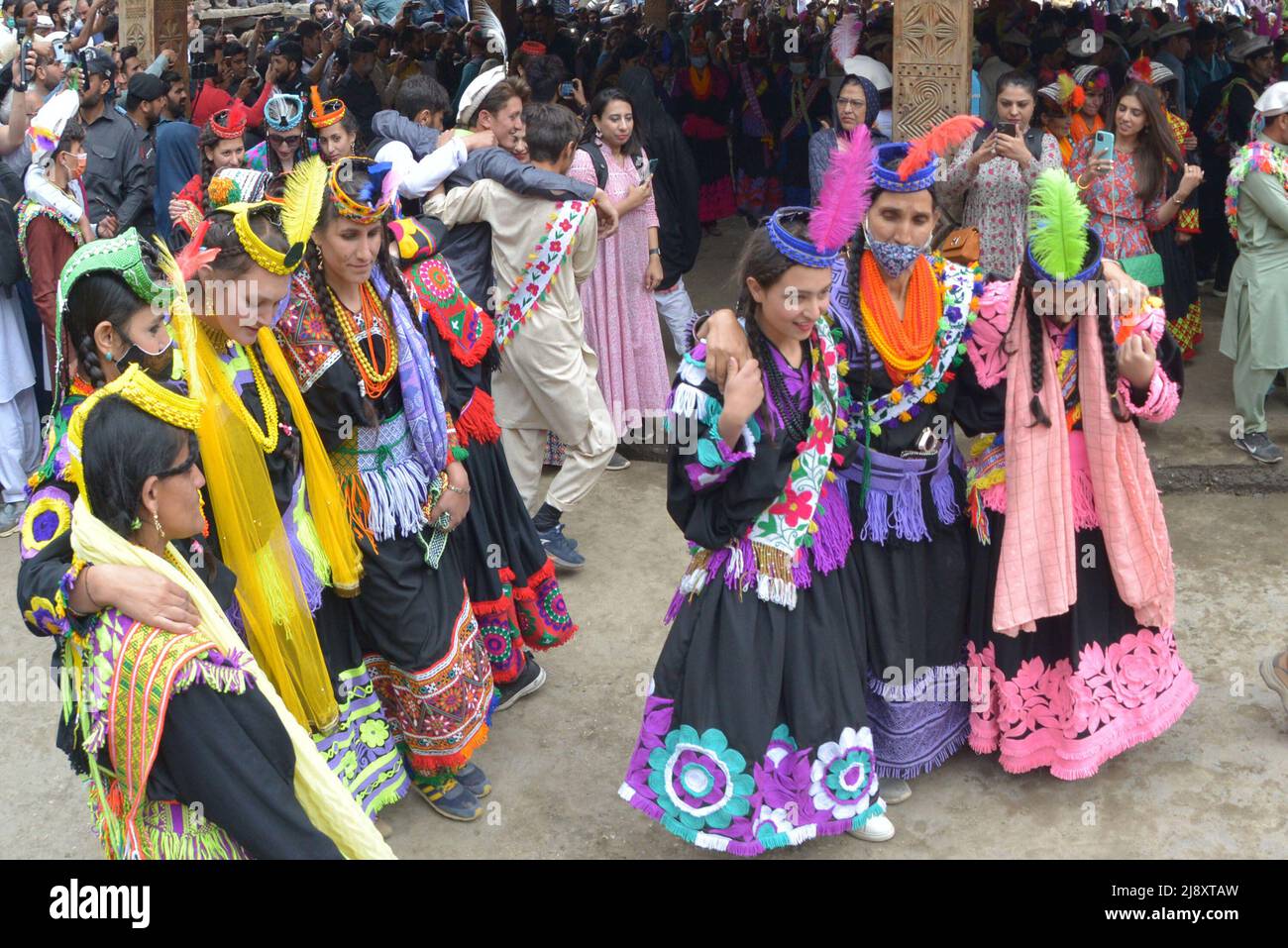 Kalashi women and men wearing traditional dresses participating in the ...