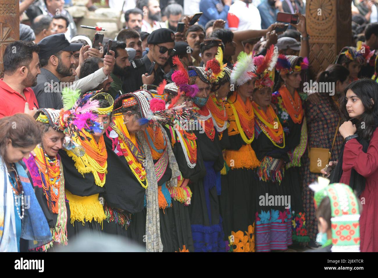 Kalashi women and men wearing traditional dresses participating in the ...