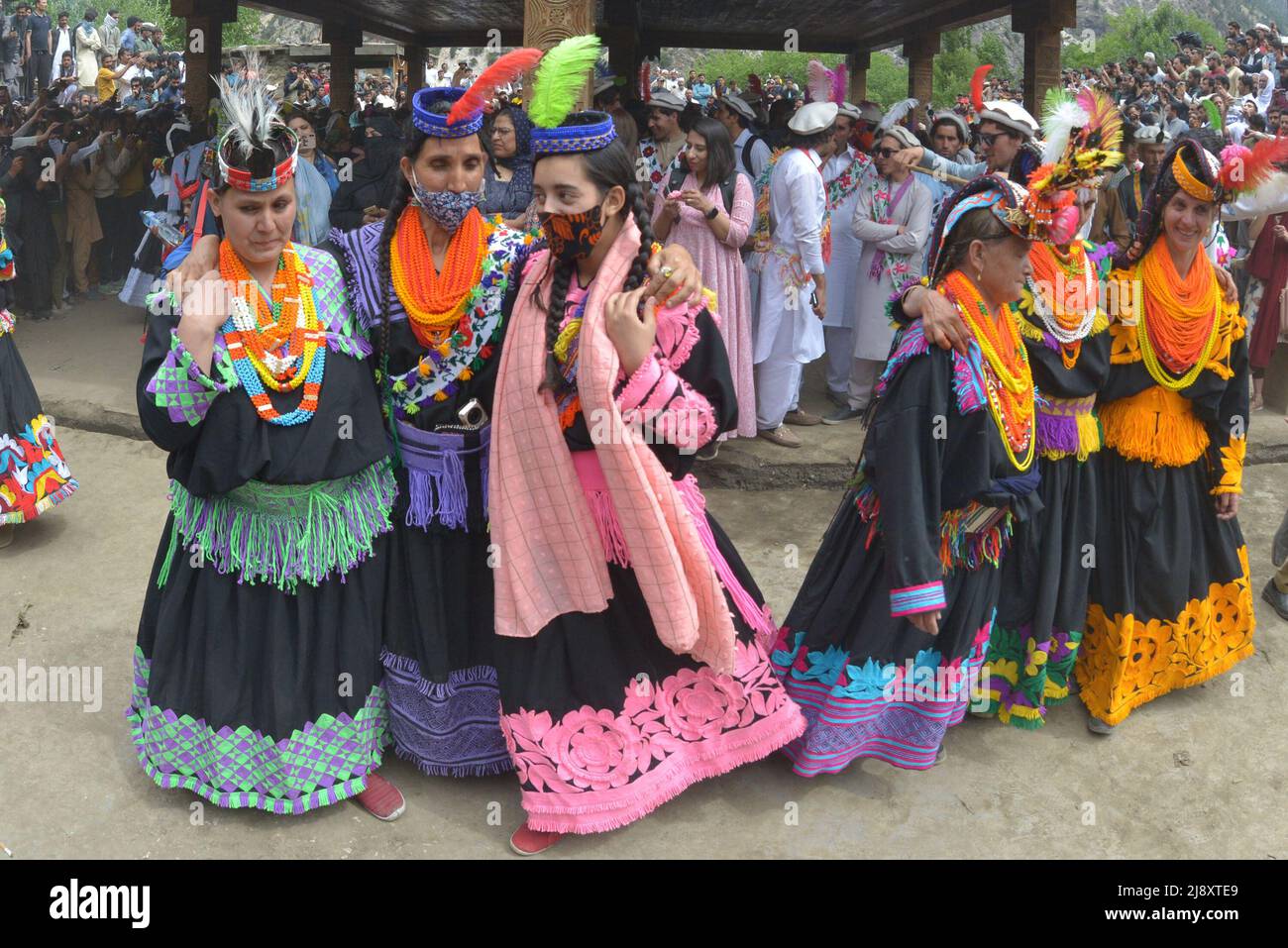 Kalashi women and men wearing traditional dresses participating in the ...