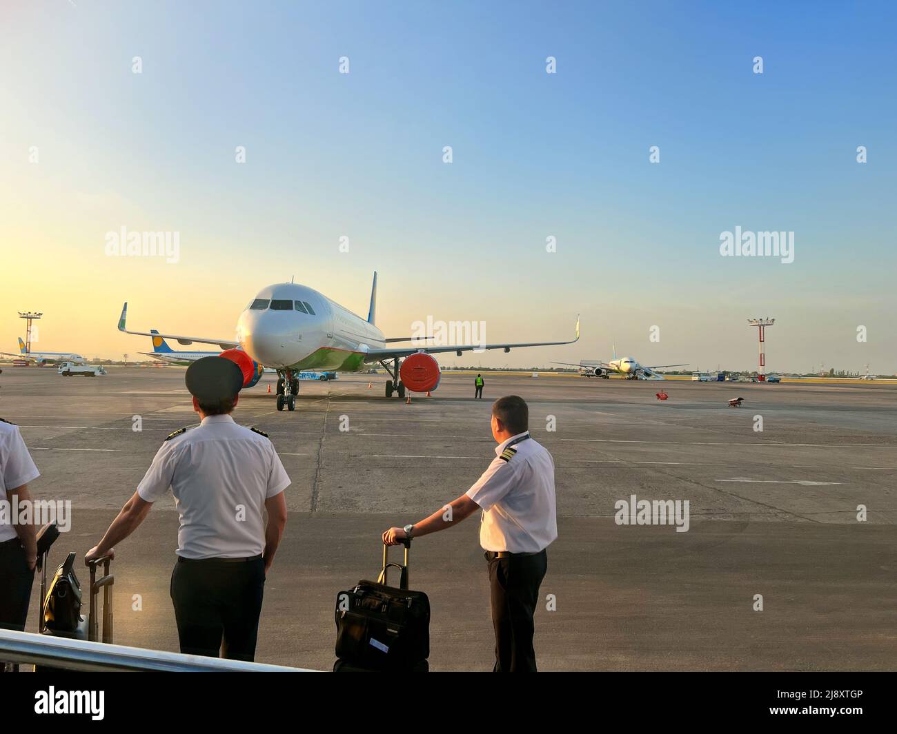 pilots stand in front of the plane Stock Photo - Alamy