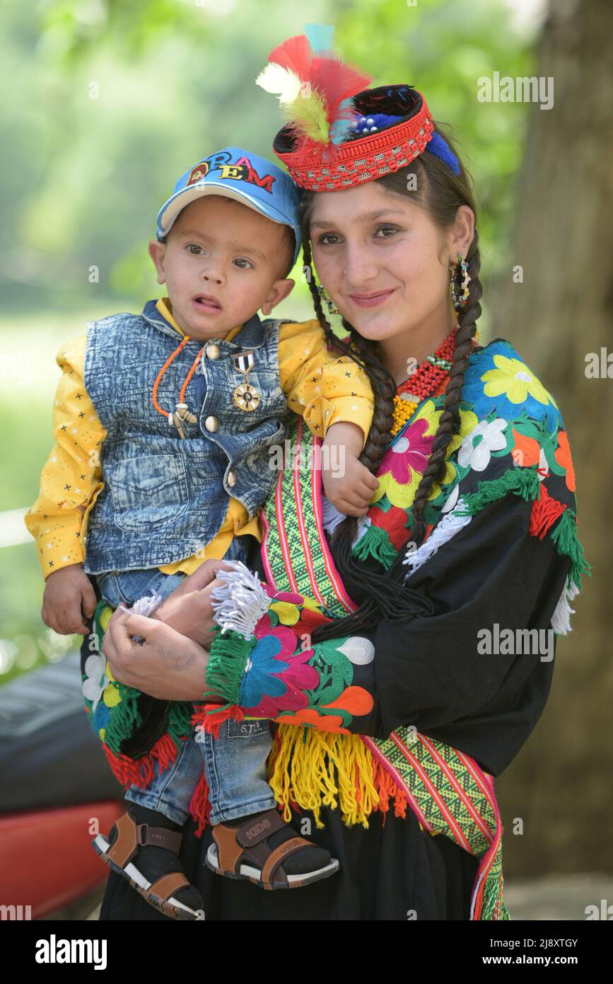 Kalashi women and men wearing traditional dresses participating in the ...