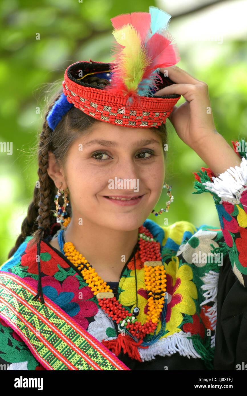 Kalashi women and men wearing traditional dresses participating in the ...