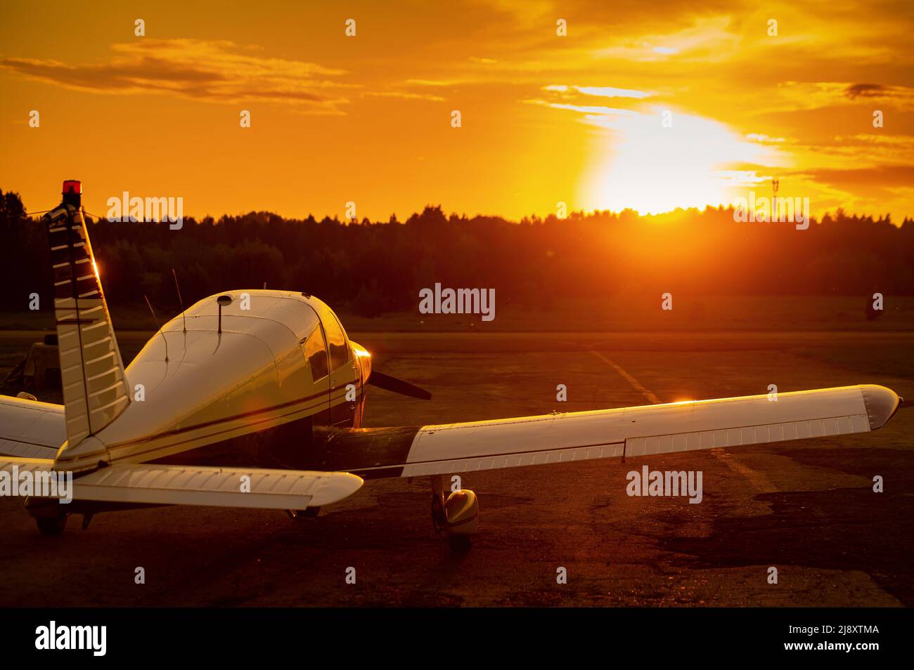 Quadruple aircraft parked at a private airfield. Rear view of a plane ...