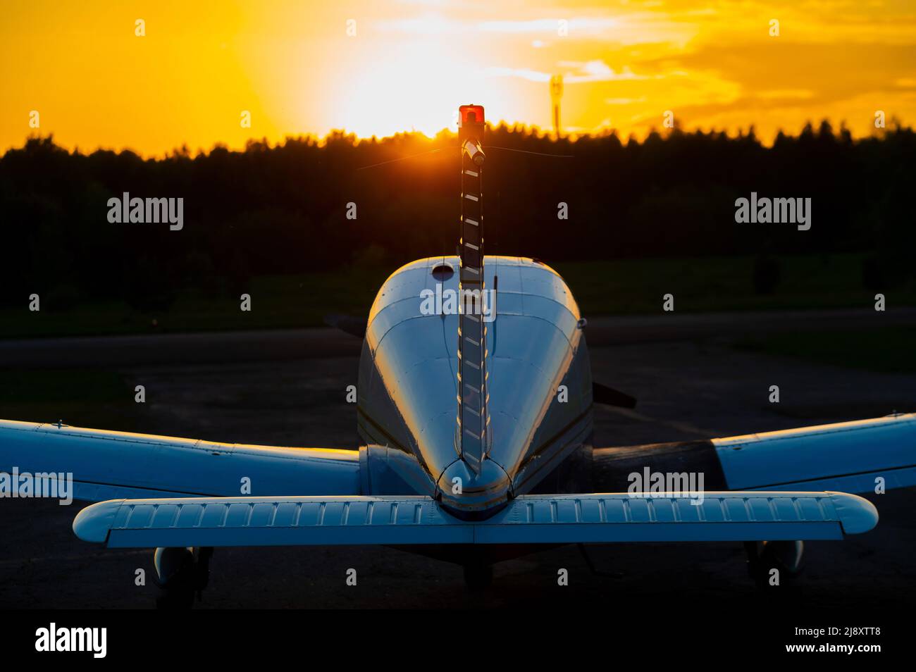 Quadruple aircraft parked at a private airfield. Rear view of a plane ...