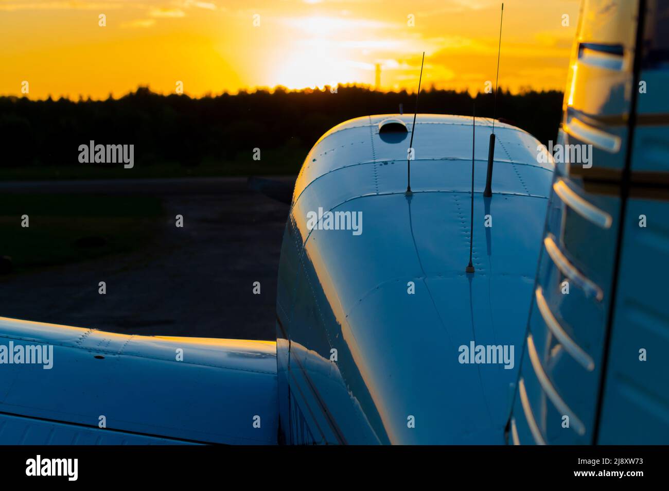 Quadruple aircraft parked at a private airfield. Rear view of a plane ...
