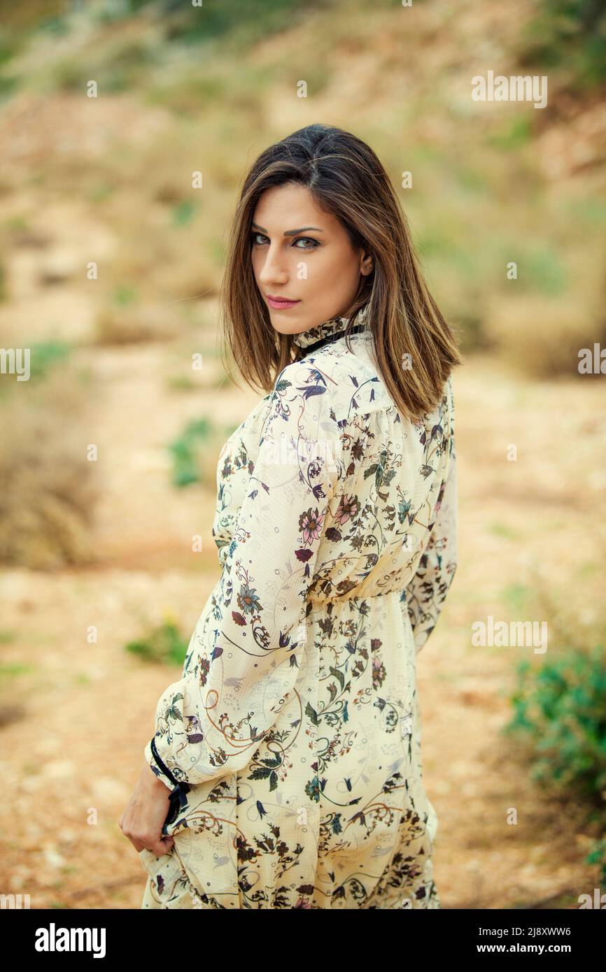 Woman looking over shoulder serious hi-res stock photography and images ...
