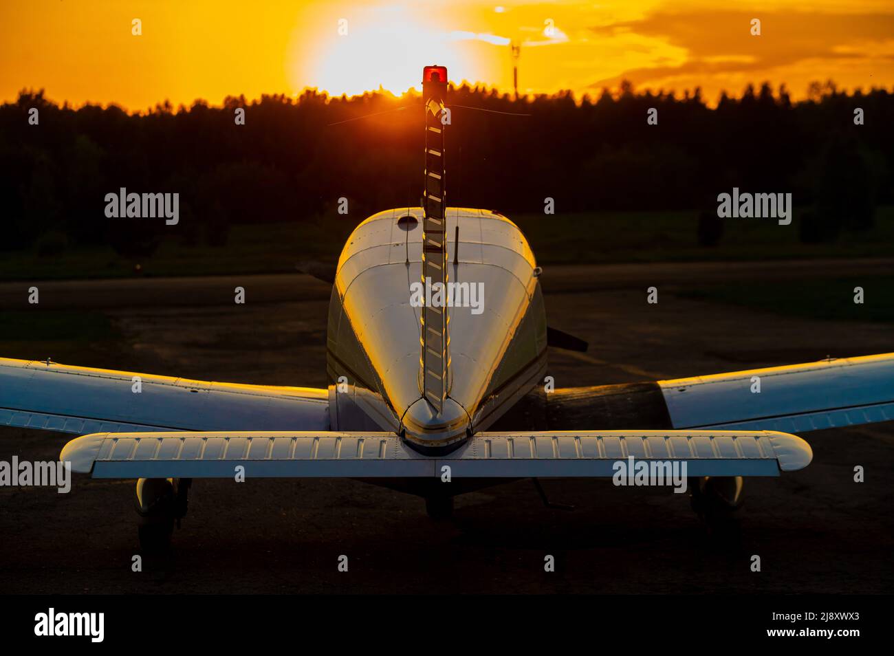 Quadruple aircraft parked at a private airfield. Rear view of a plane ...