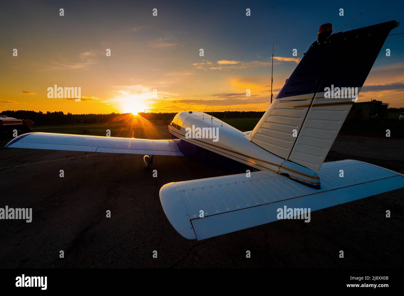 Quadruple aircraft parked at a private airfield. Rear view of a plane ...