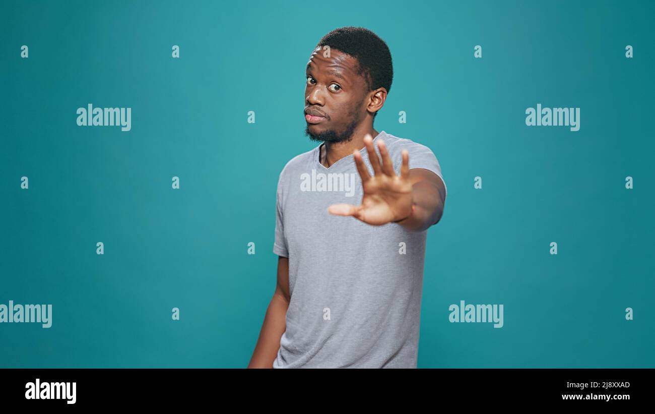 Portrait of person doing talk to the hand rejection gesture, expressing ...