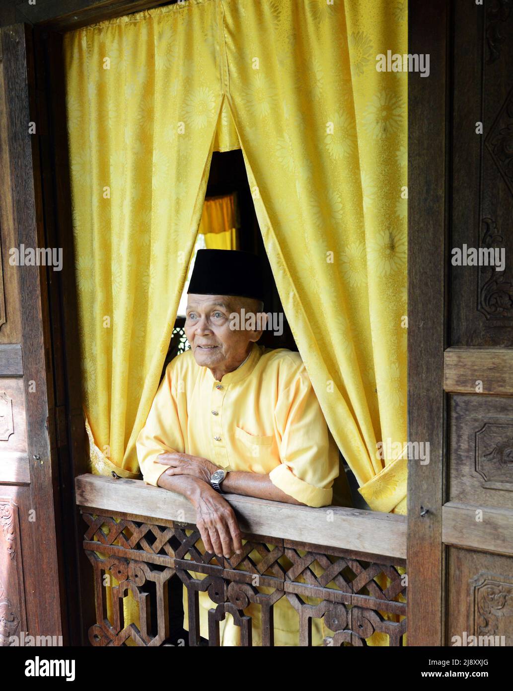 A Malay man wearing a traditional cap Stock Photo - Alamy