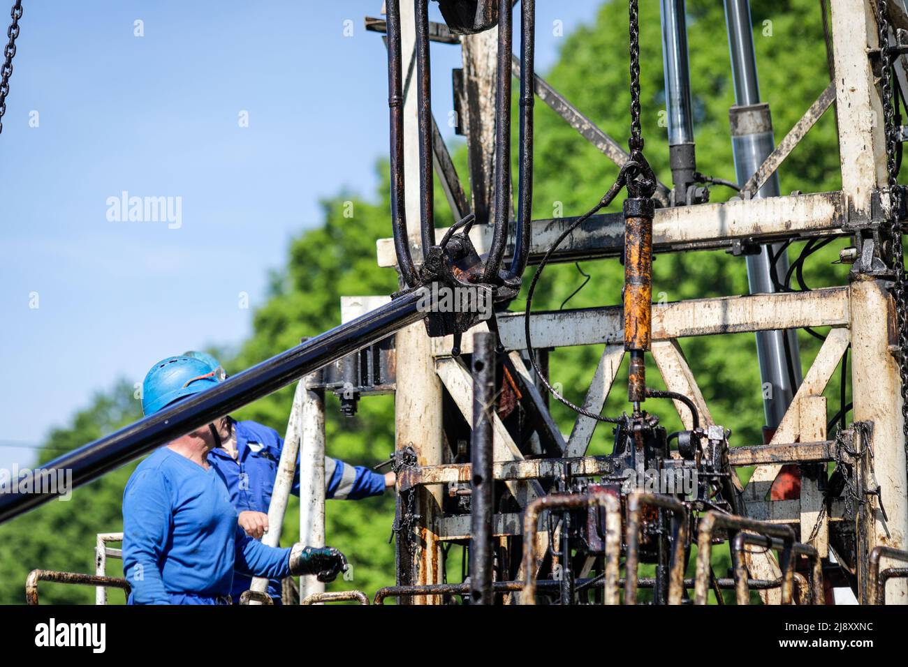 Oil and gas industry worker operates oil rig drill pipes on an oil well ...
