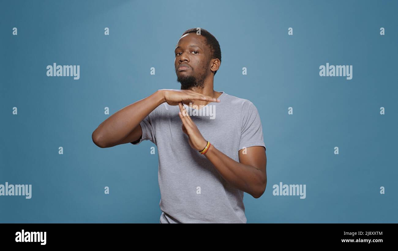 African american man doing timeout gesture with t shape hands ...