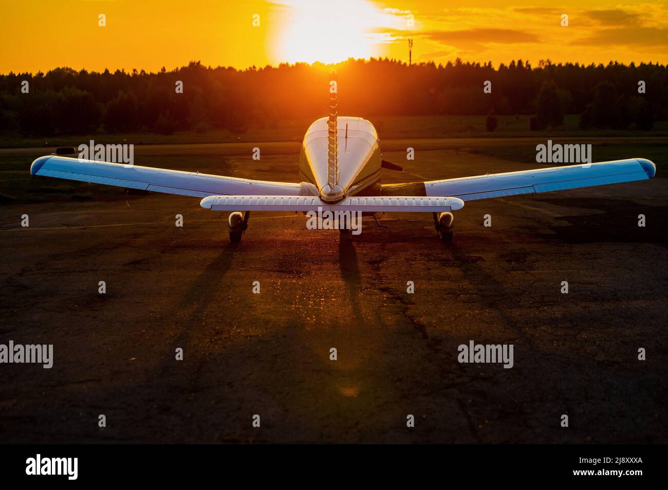 Quadruple aircraft parked at a private airfield. Rear view of a plane ...