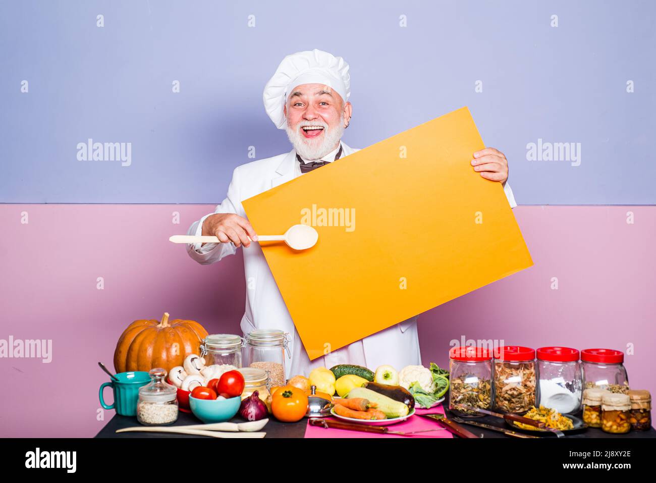 Amazed chef pointing spoon on blank board menu. Cooking, profession ...