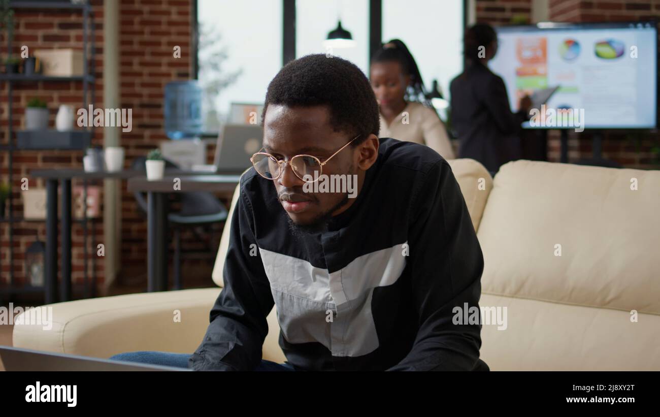 African american employee planning financial analysis on laptop ...