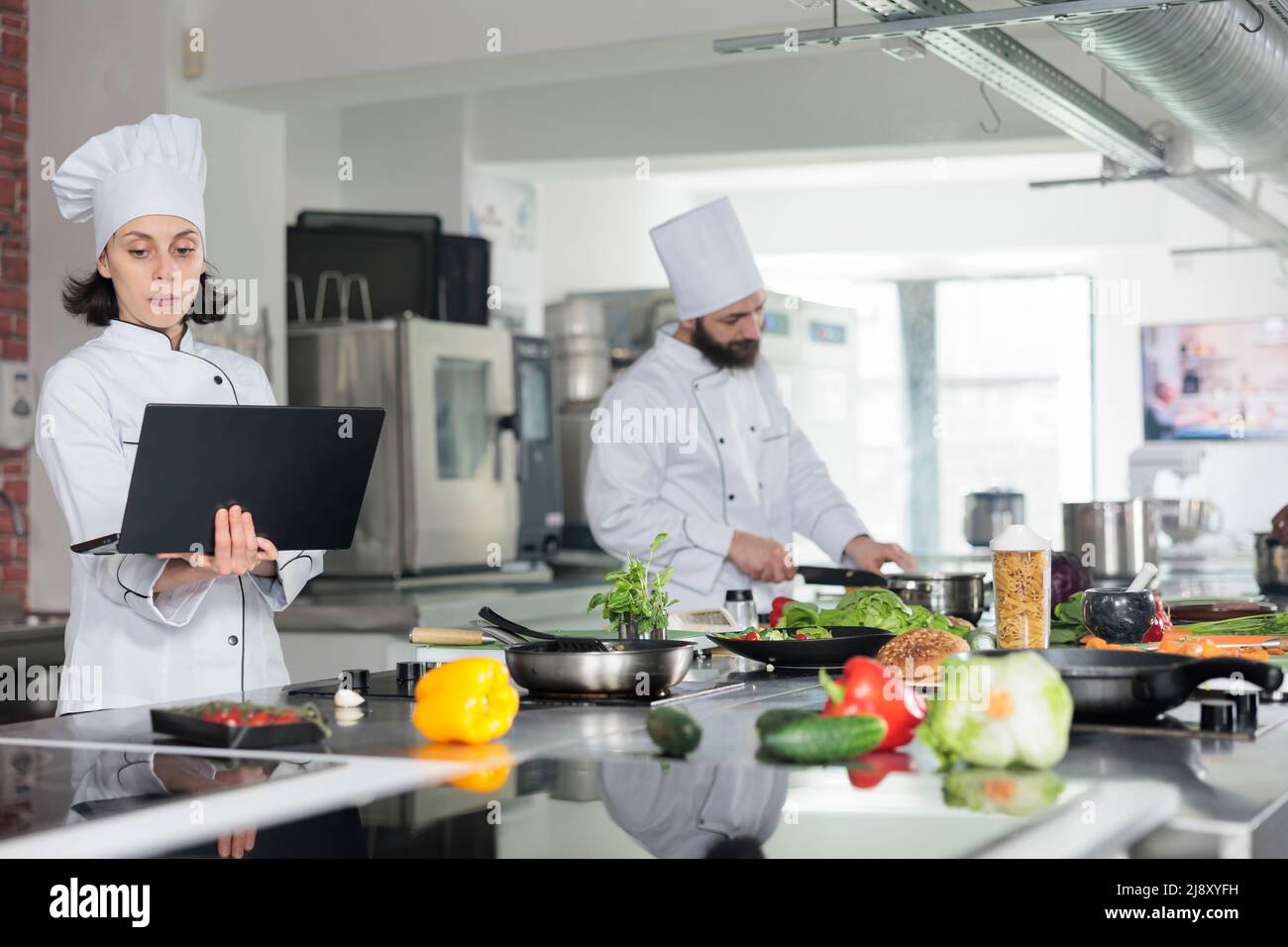 Professional food industry worker with computer searching for ...