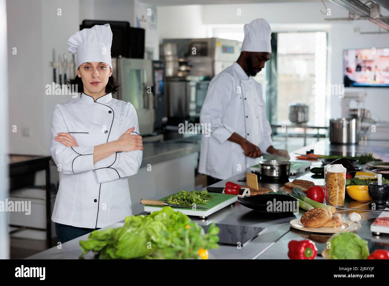 Gourmet cuisine expert standing in restaurant professional kitchen with ...