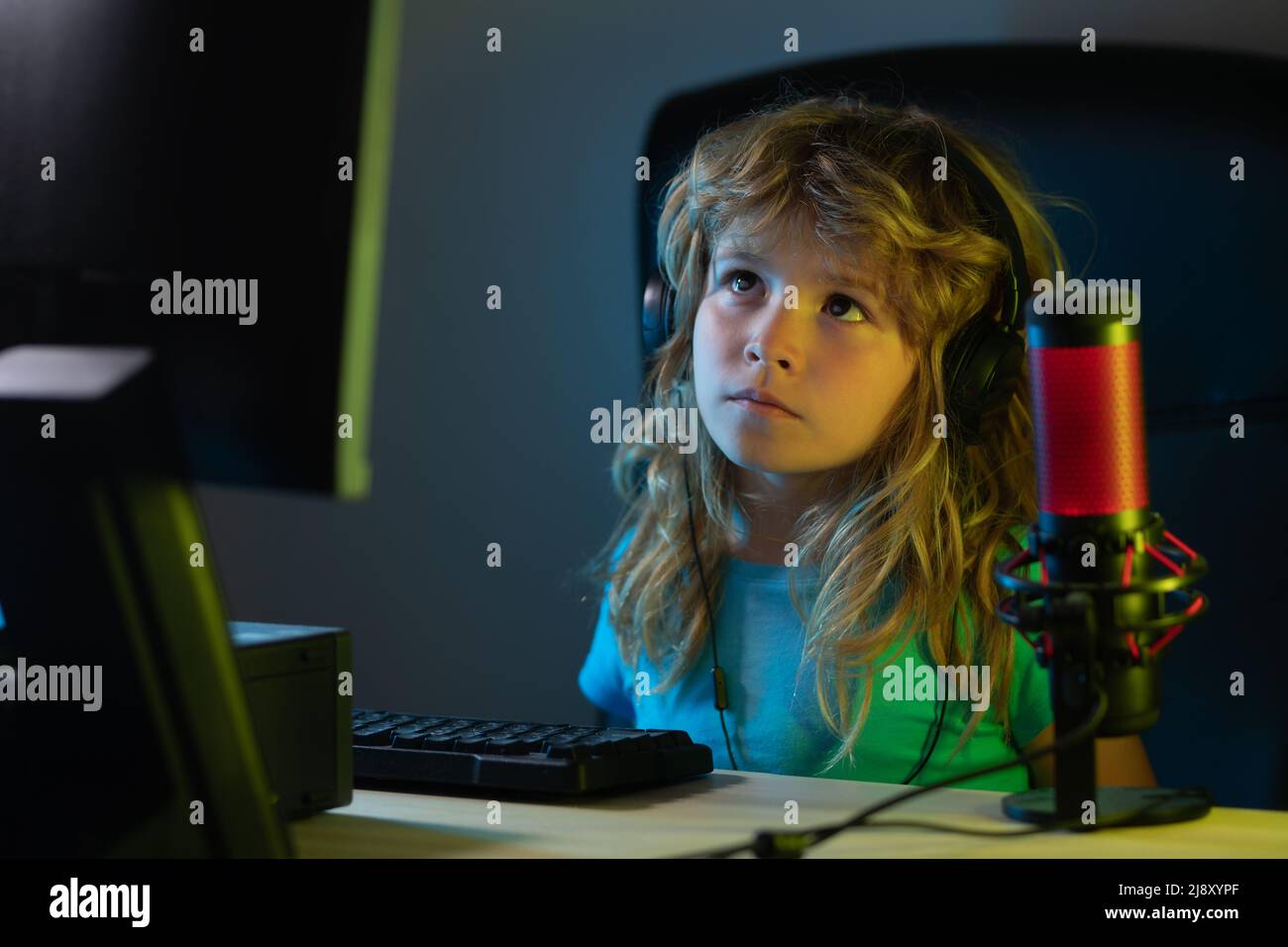 Child playing computer games or studying on pc computer. Kid gamer on ...