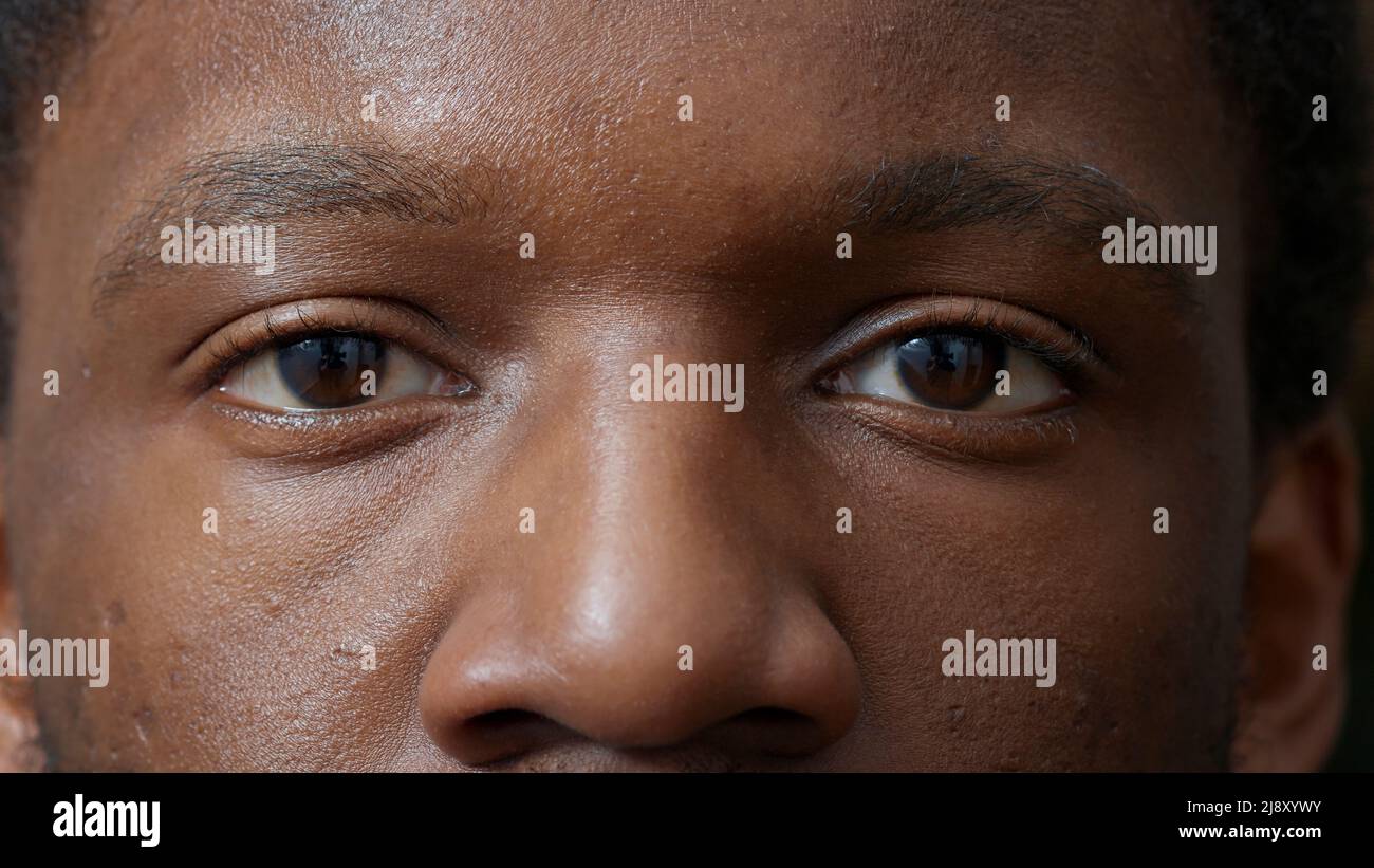 Macro shot of young adult blinking in front of camera, showing eyes ...