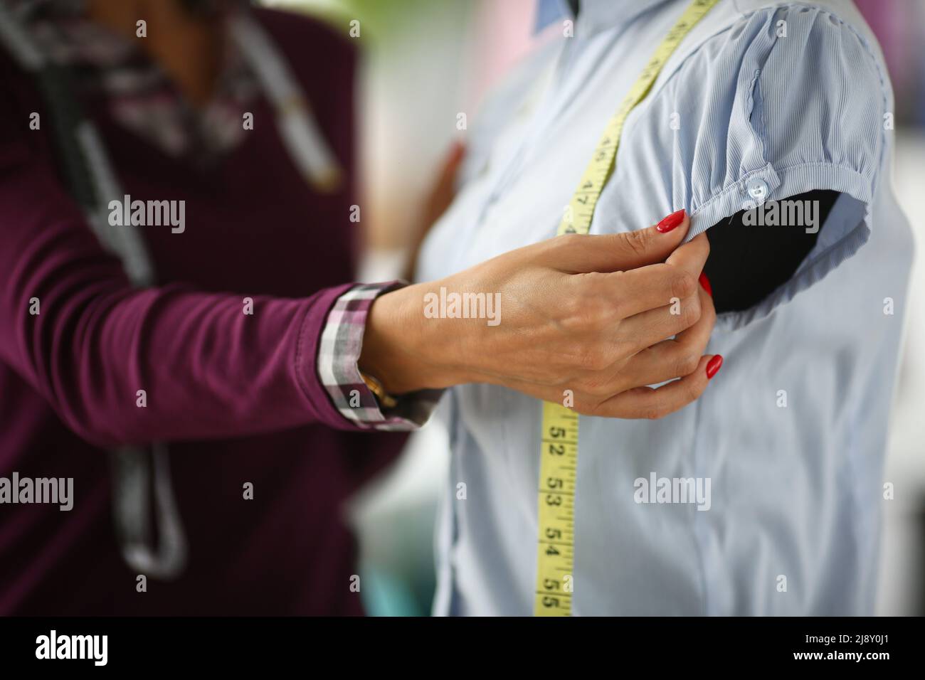 Woman dressmaker making measurements on mannequin, fashion industry Stock Photo - Alamy