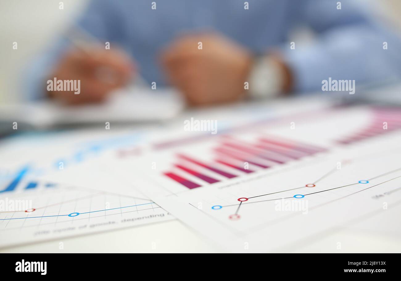 Agreement form, annual report in finance, mess with papers on desk ...