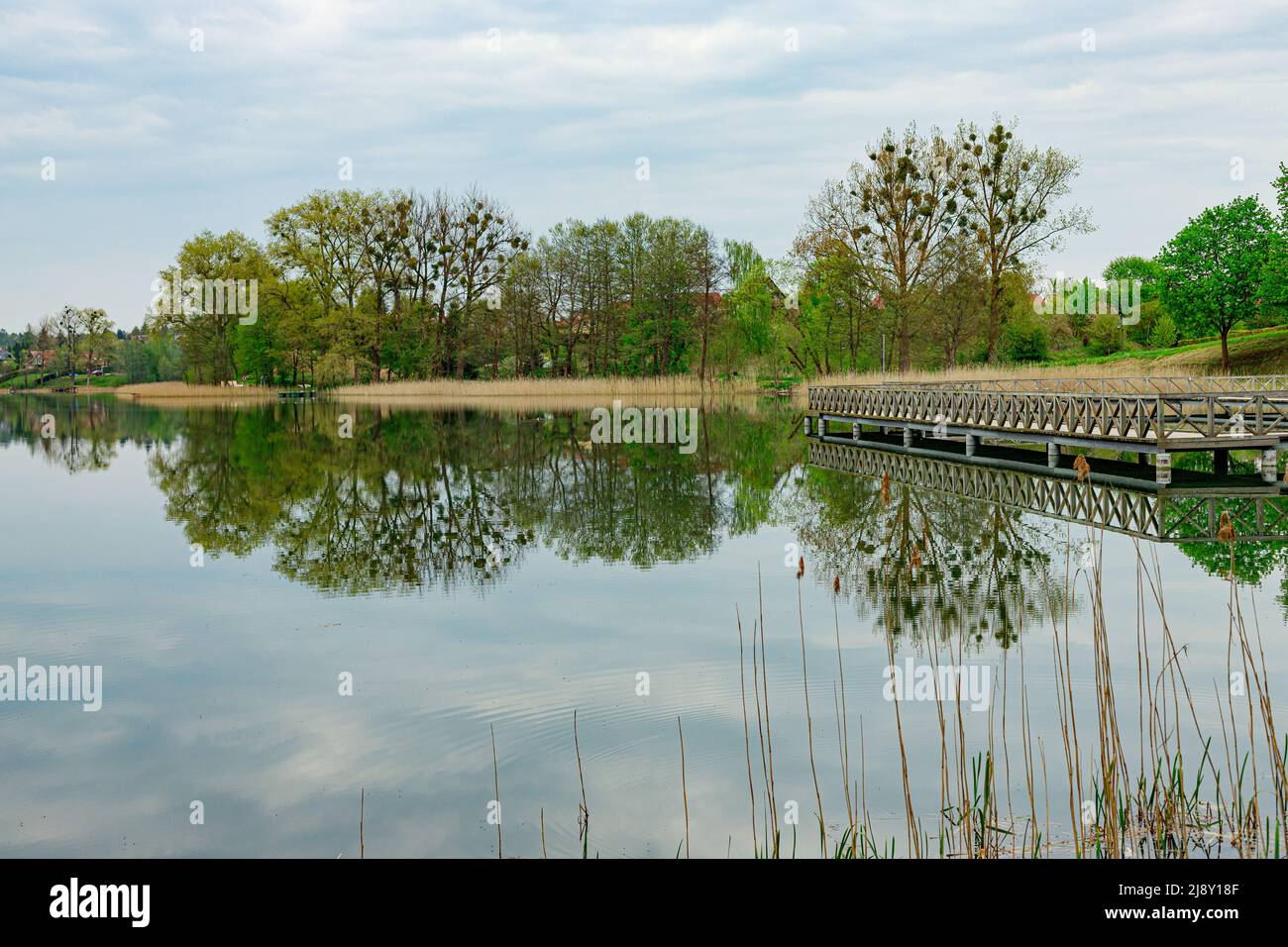 View of the city beach and Ryn. A view of the Ołów Lake in the town of ...