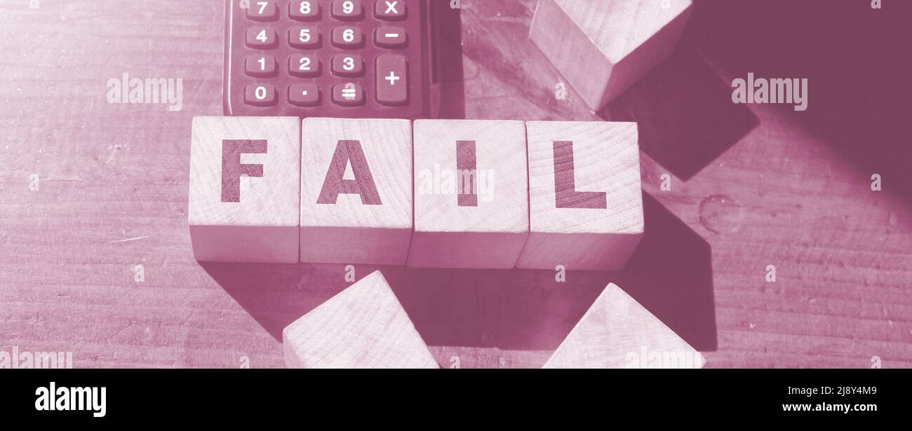 Fail word from wooden blocks and calculator on desk. Business crisis ...
