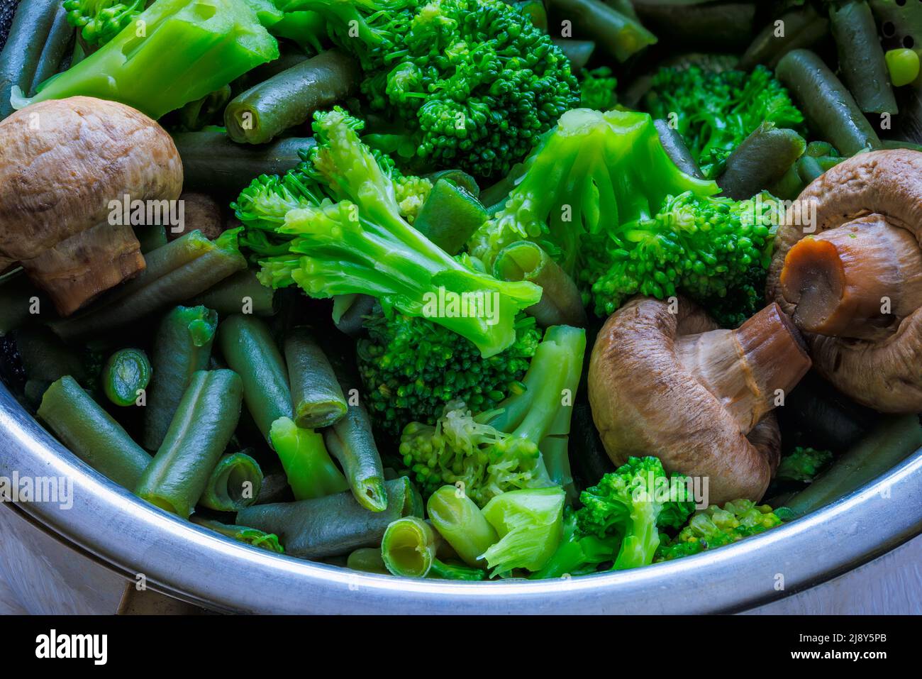 boiled green vegetables in stainless steel colander - full-frame ...