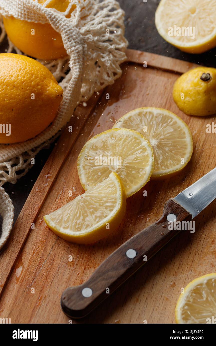 Fresh juicy lemon slices on a dark background vertical Stock Photo - Alamy