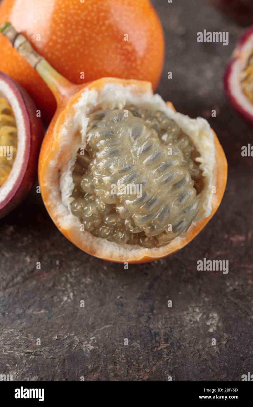 Tropical fruits on a dark background table Stock Photo - Alamy