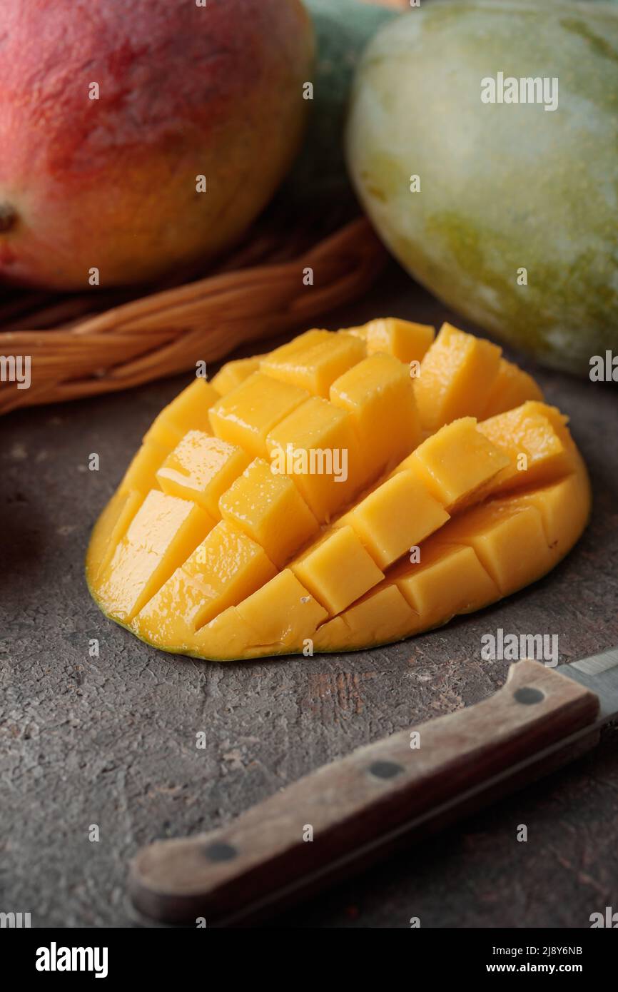 Mango fruit on a dark table background Stock Photo - Alamy