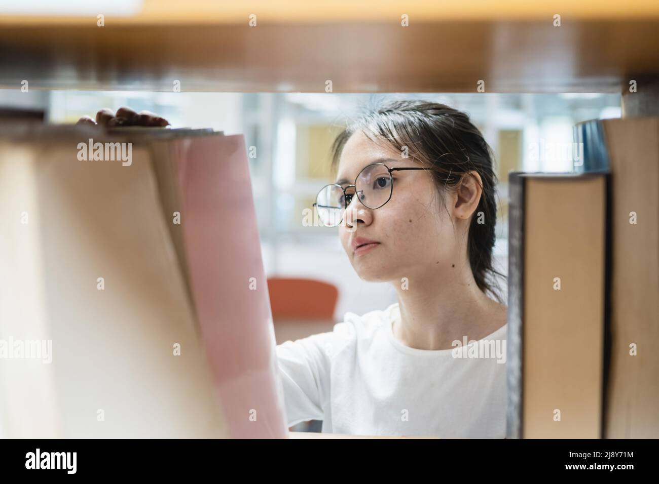 Asian holding library books hi-res stock photography and images - Alamy
