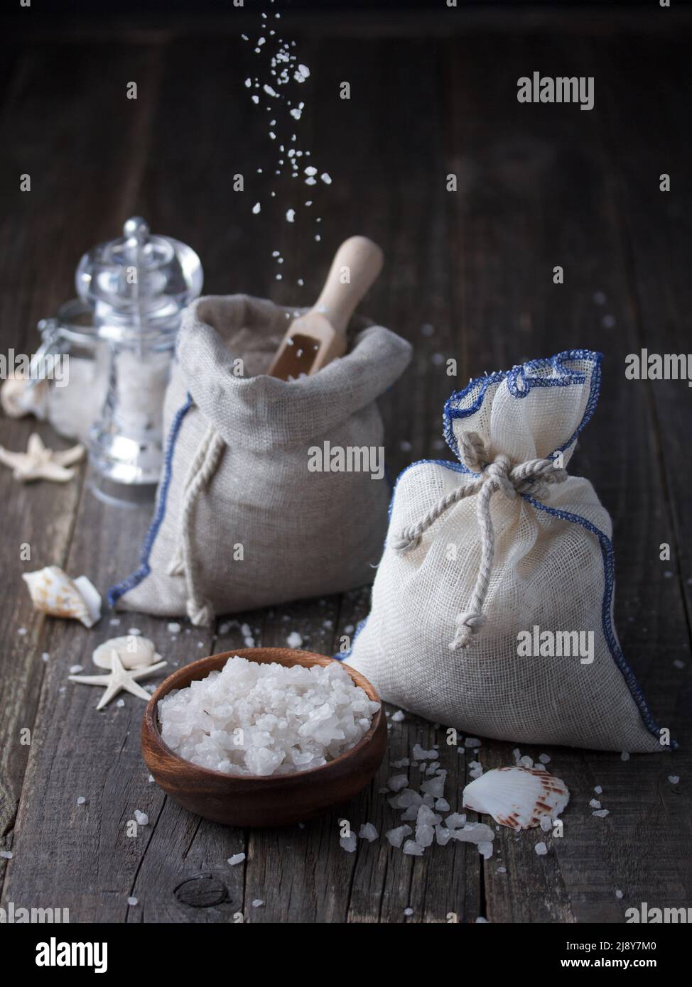 Sea salt crystals with seashells on a dark background Stock Photo - Alamy