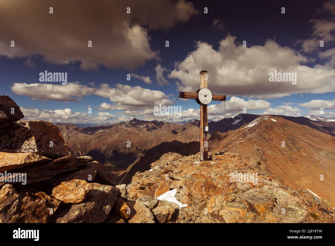 Alpine summit with cross and majestic alpine panorama background at ...