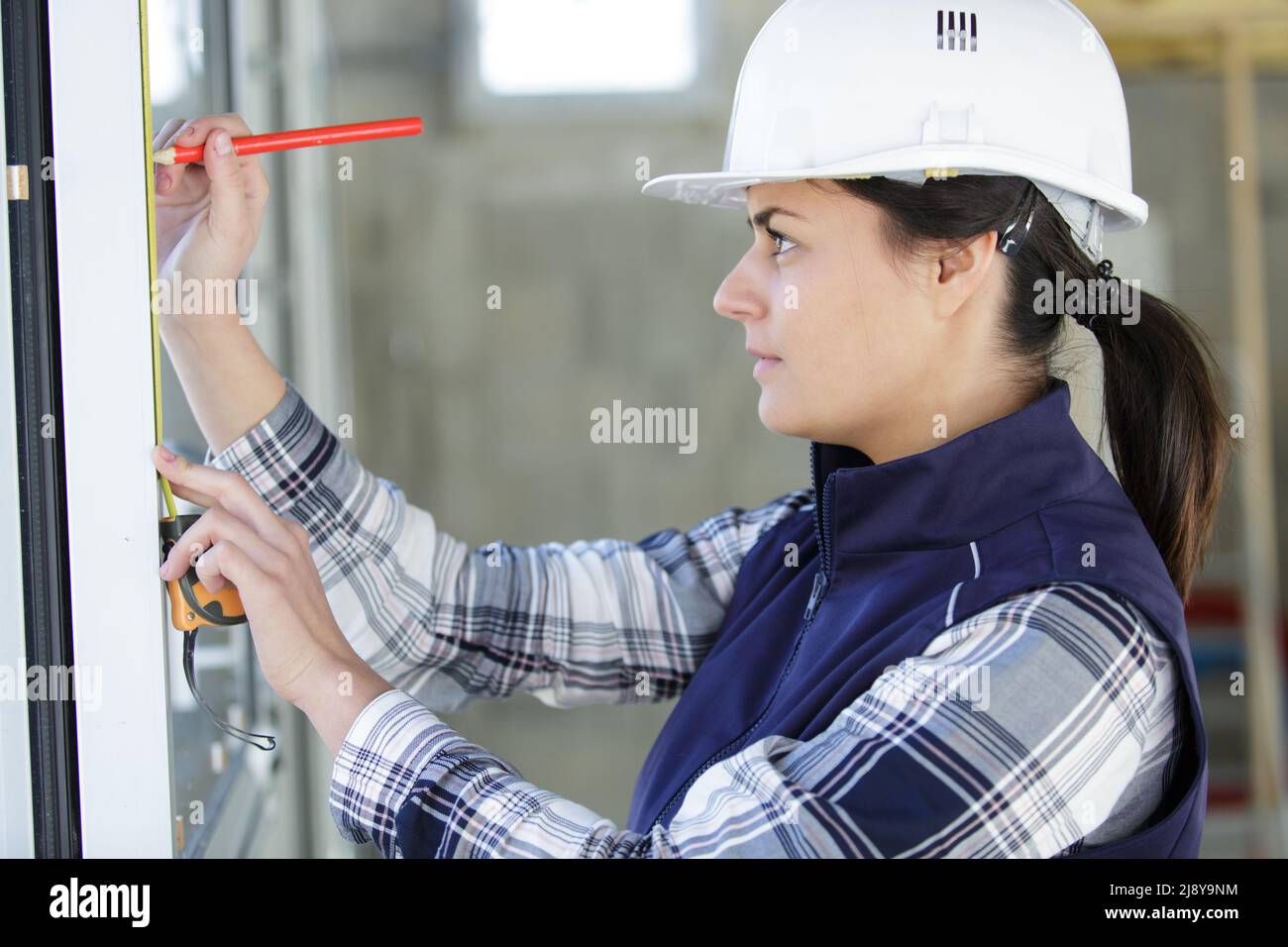 woman measuring window frame in construction site Stock Photo - Alamy woman measuring window frame in construction site Stock Photo - Alamy