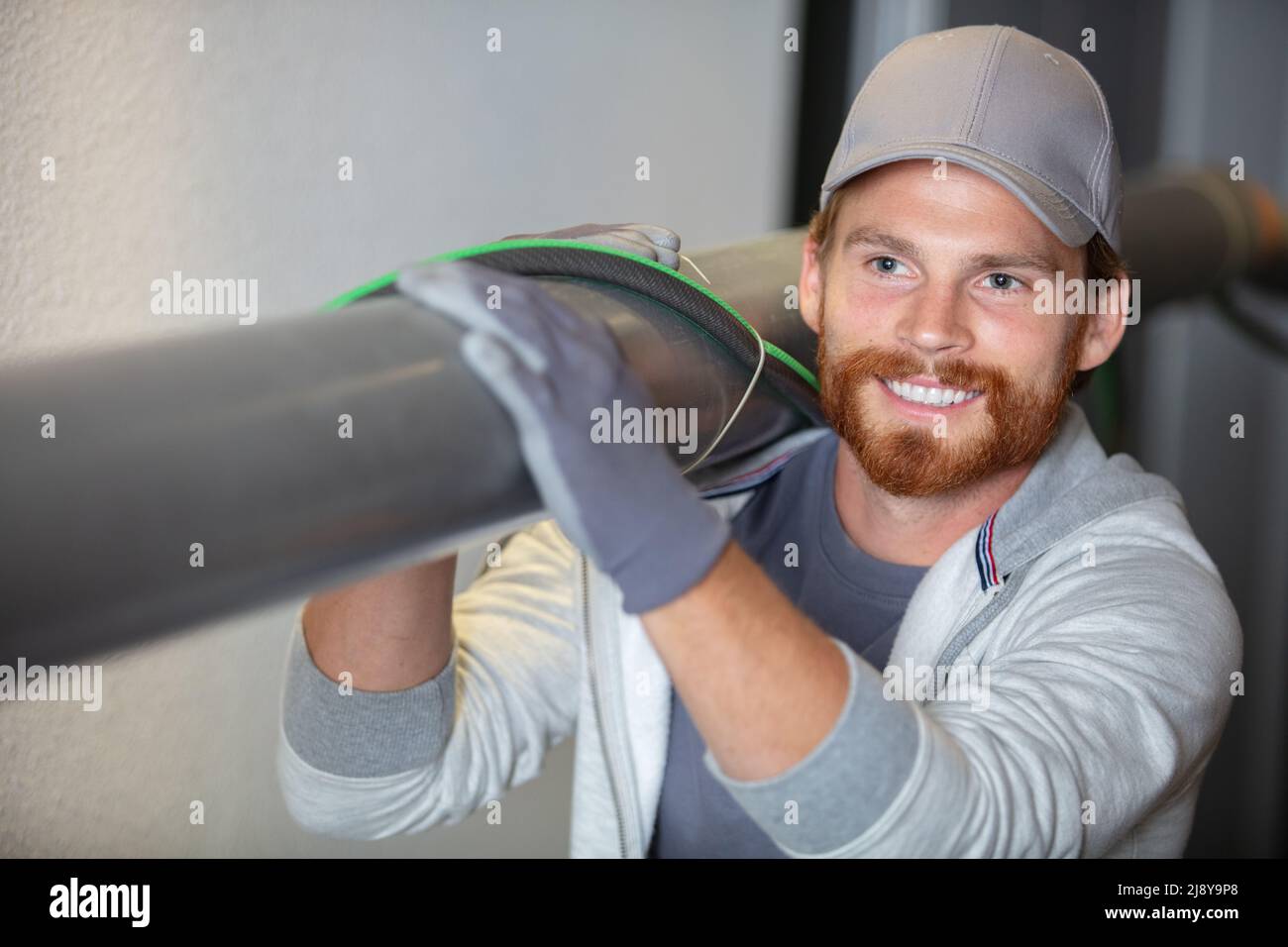 Construction worker carrying pipe hi-res stock photography and images ...