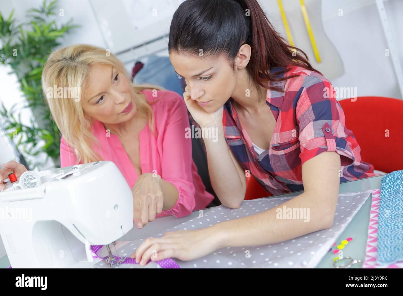 young woman learning to sew Stock Photo - Alamy