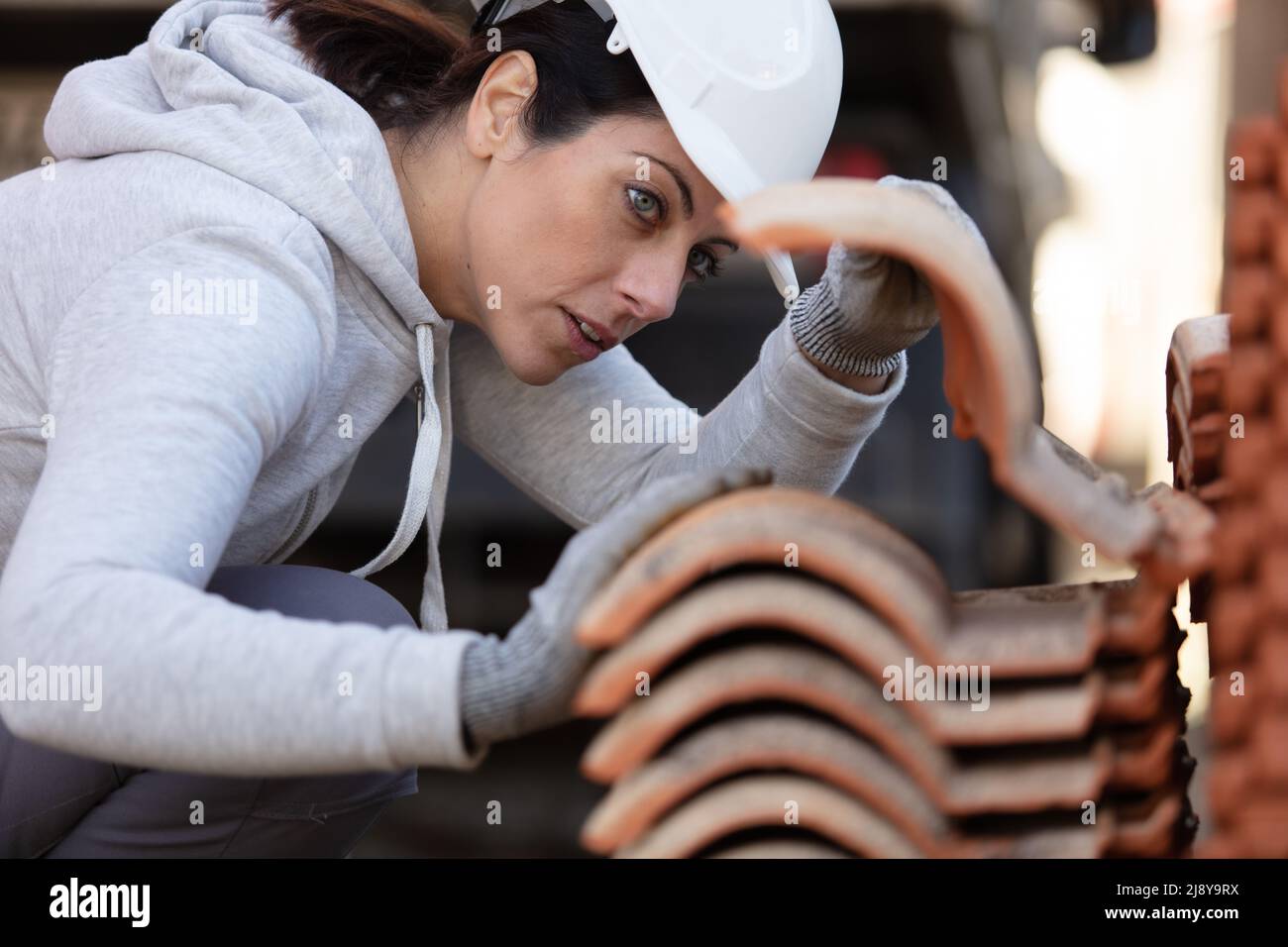 female bricklayer working with brick blocks Stock Photo - Alamy