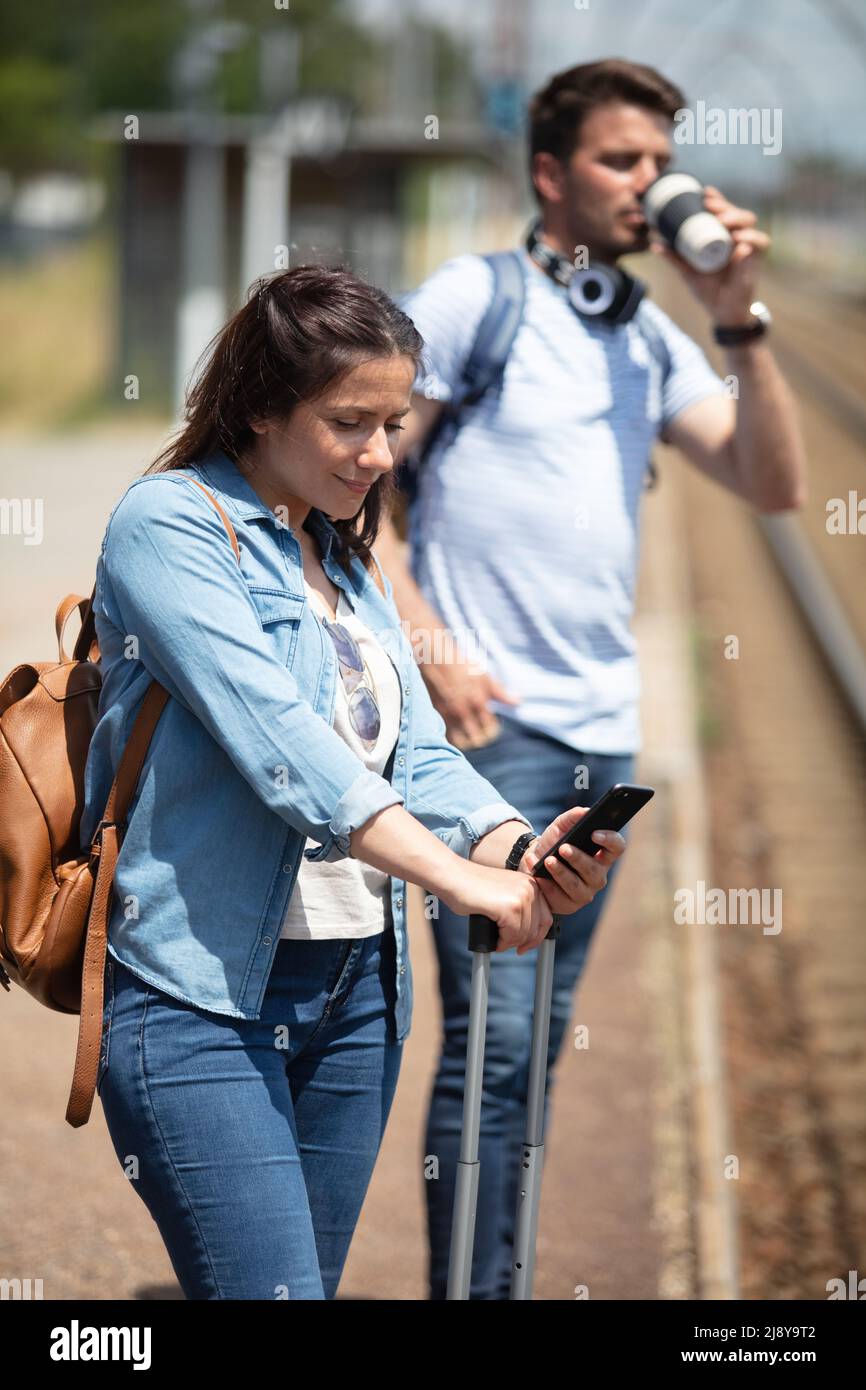 group of friends waiting the train Stock Photo - Alamy