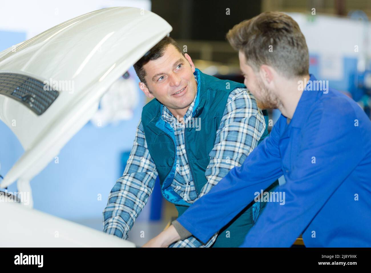 two mechanics repairing a car Stock Photo - Alamy