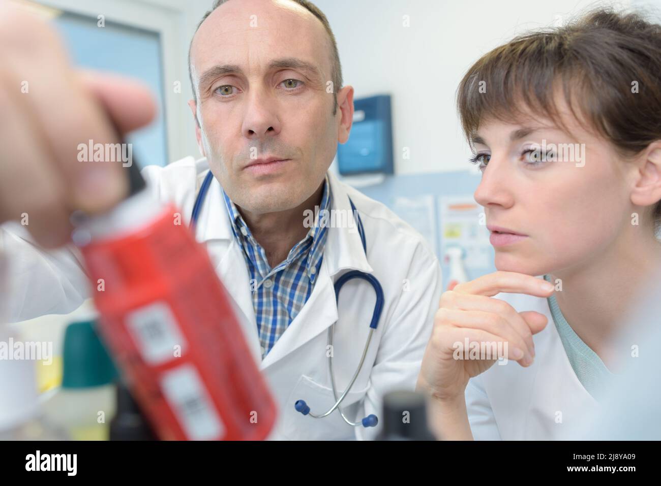 nurse an doctor checking a bottle of medicine Stock Photo - Alamy