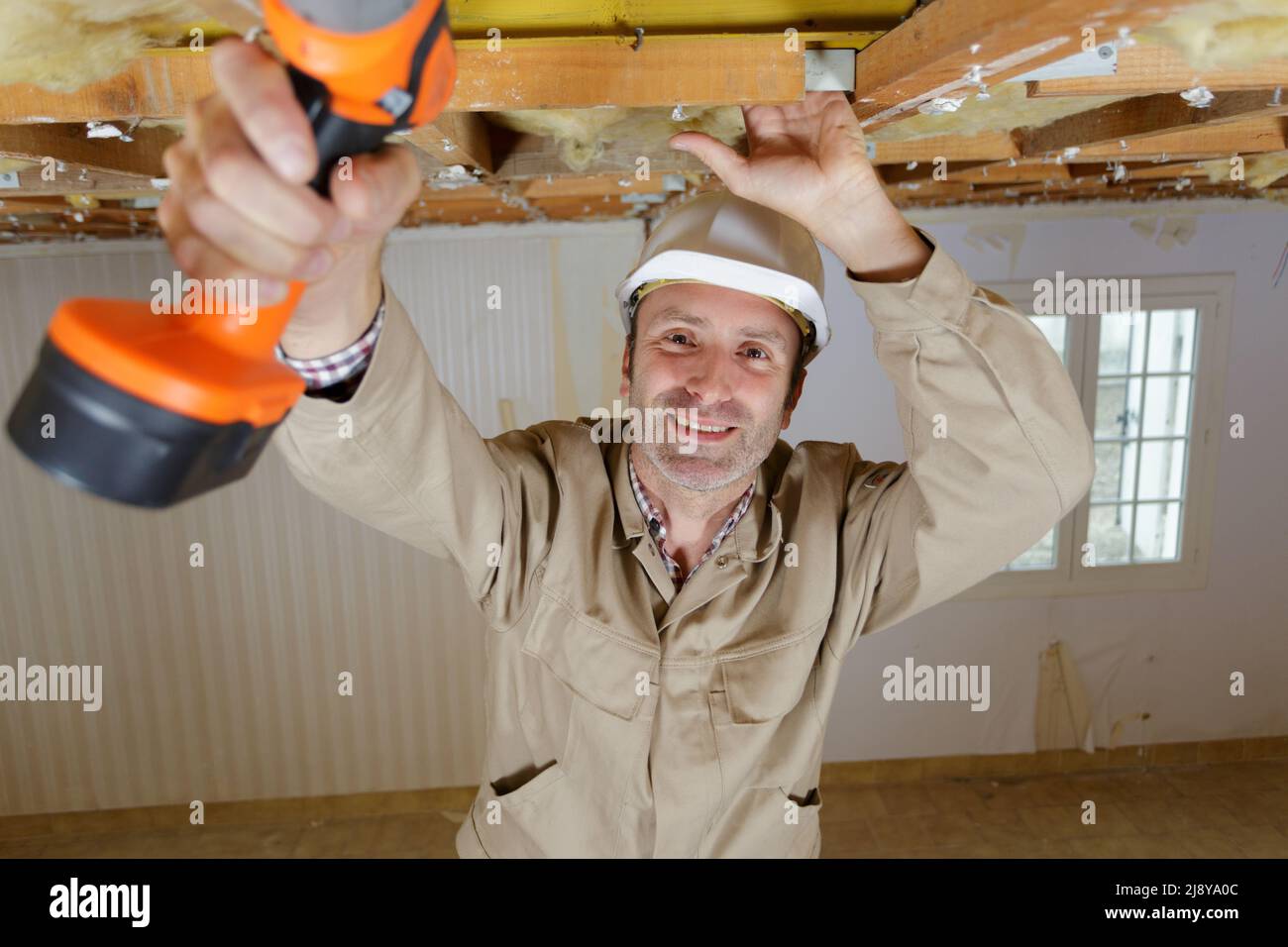 man is building a wooden house structure Stock Photo - Alamy