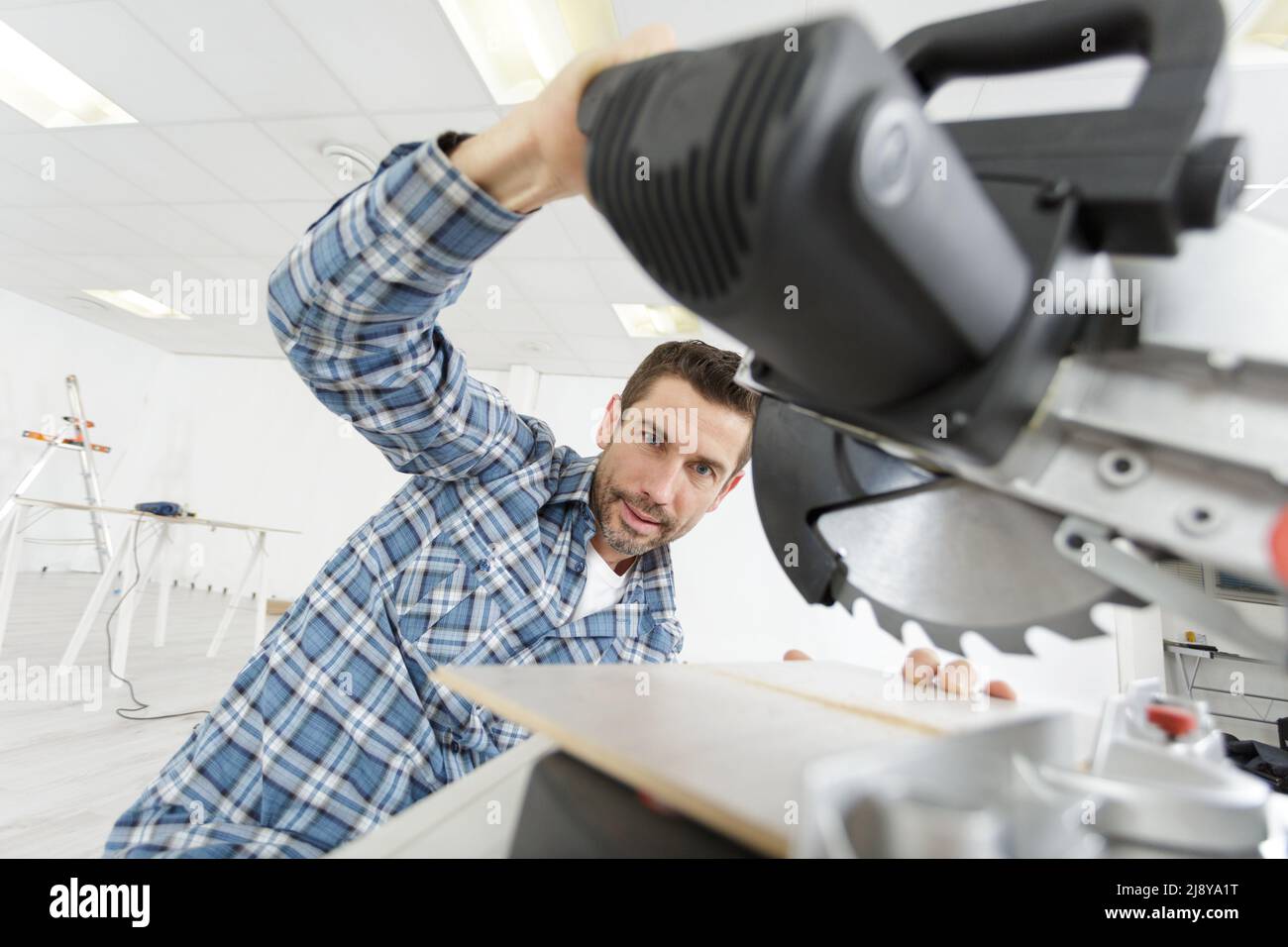 happy man using a circular saw Stock Photo - Alamy