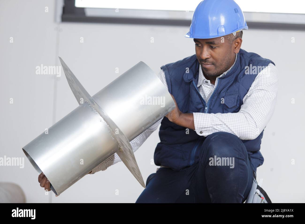 happy modern blue collar worker in factory Stock Photo - Alamy