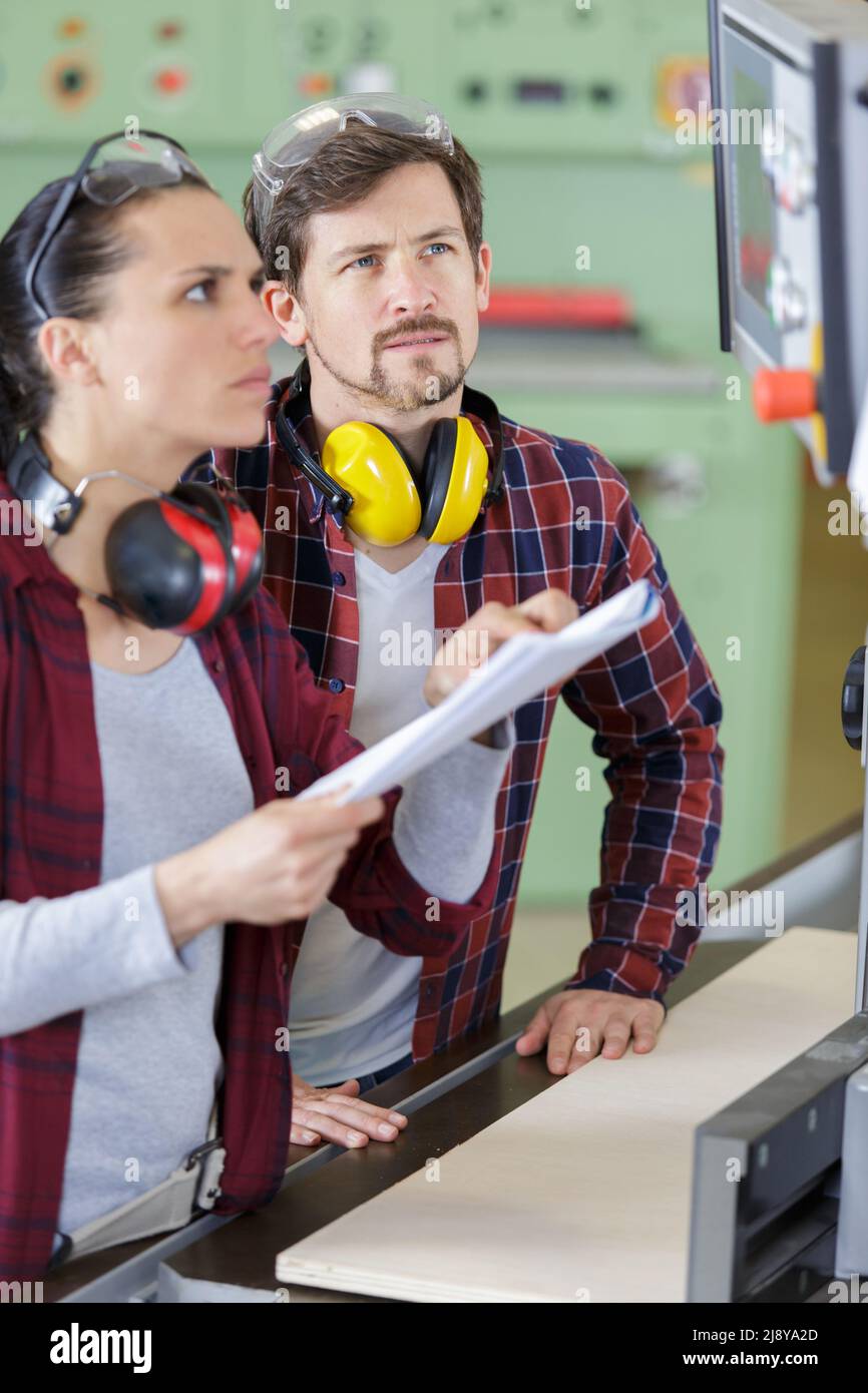 engineer showing apprentice how to use cnc tool making machine Stock ...